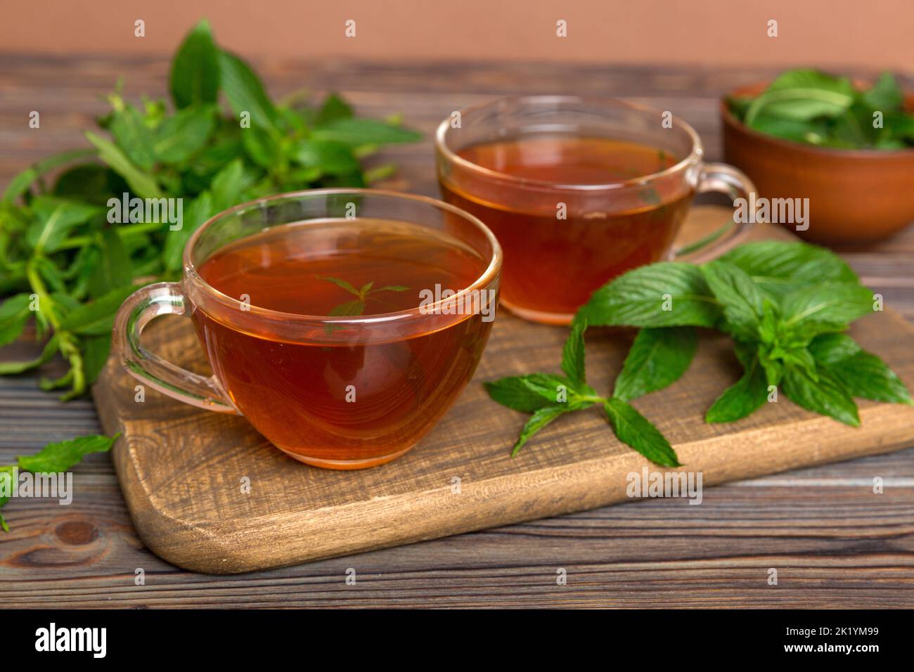 Cup of mint tea on table background. Green tea with fresh mint top view ...
