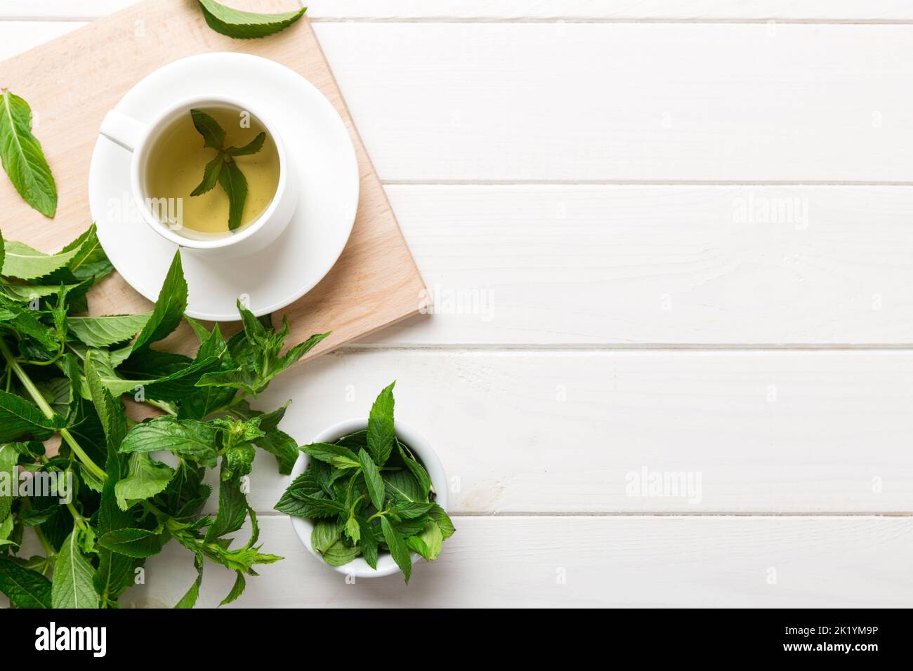 Cup of mint tea on table background. Green tea with fresh mint top view ...