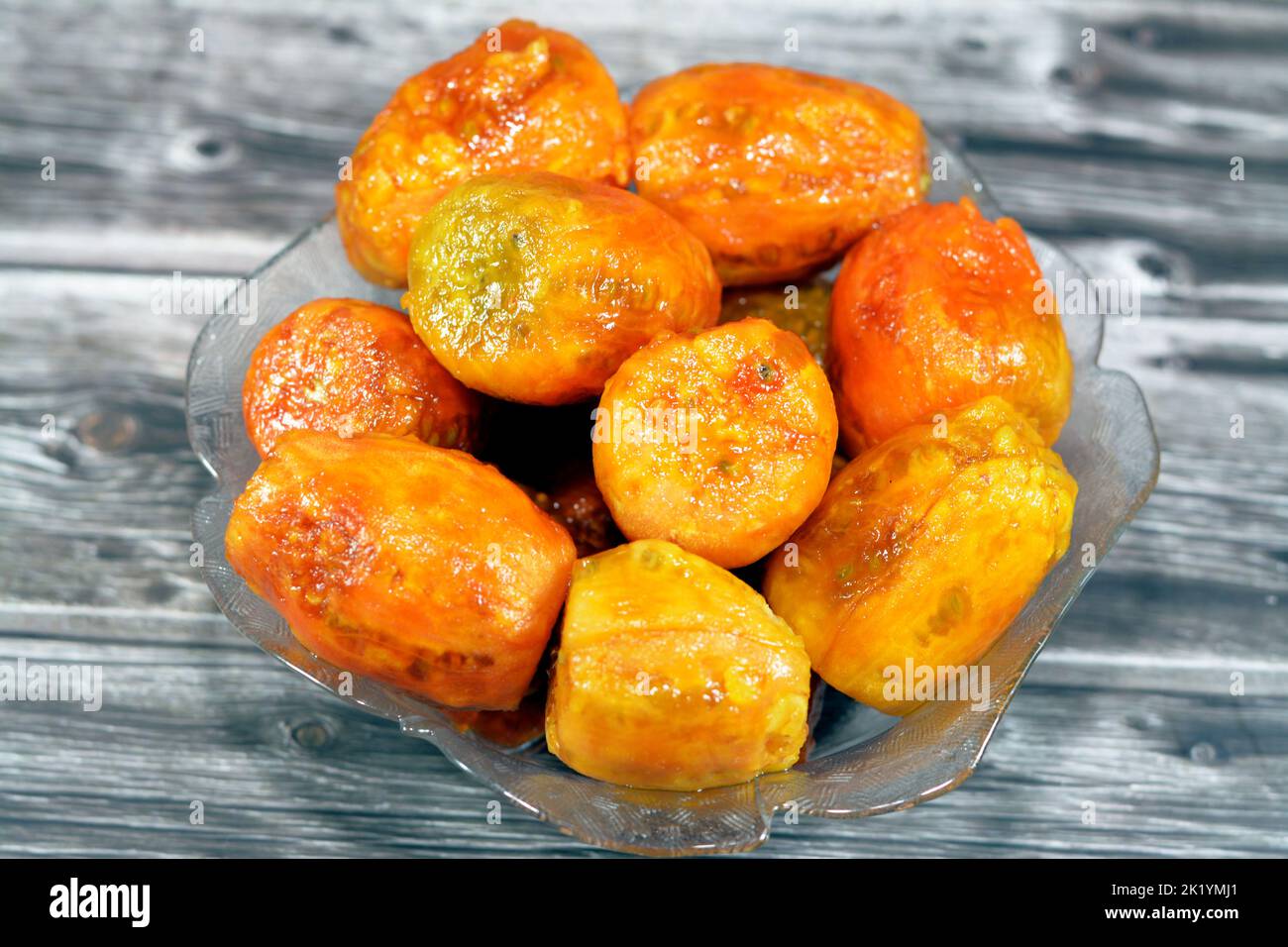 A pile of peeled fresh prickly pear fruit in a glass bowl isolated on ...
