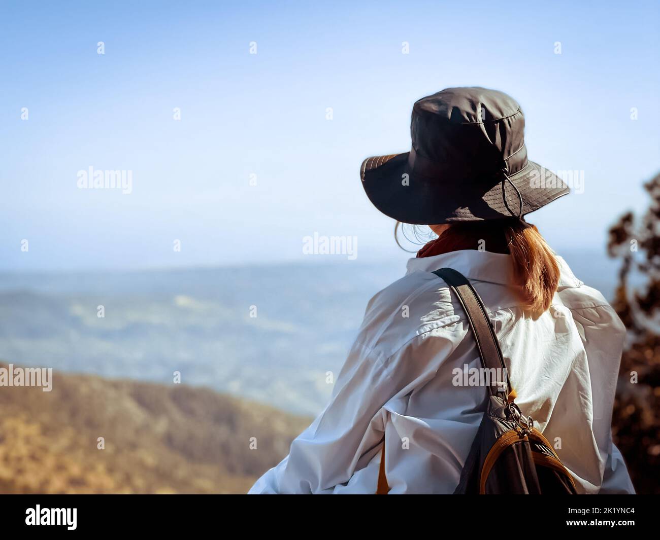 Woman watching beautiful nature mountain landscape sitting on viewpoint ...
