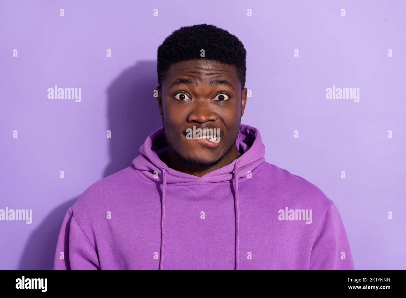 Portrait of attractive funny worried guy biting lip oops isolated over ...