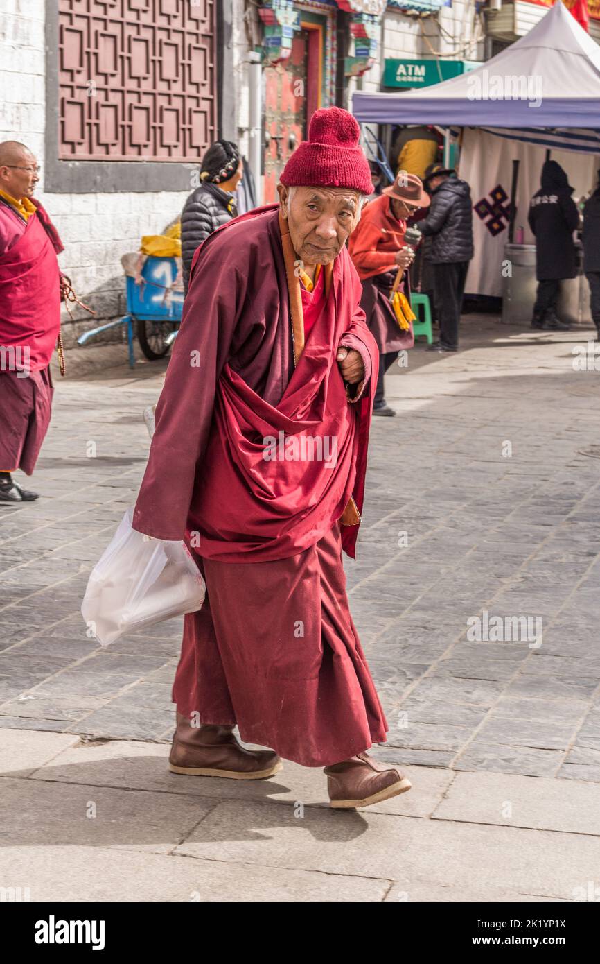 Tibetan buddhist pilgrims undertake the Kora clockwise circumambulation ...