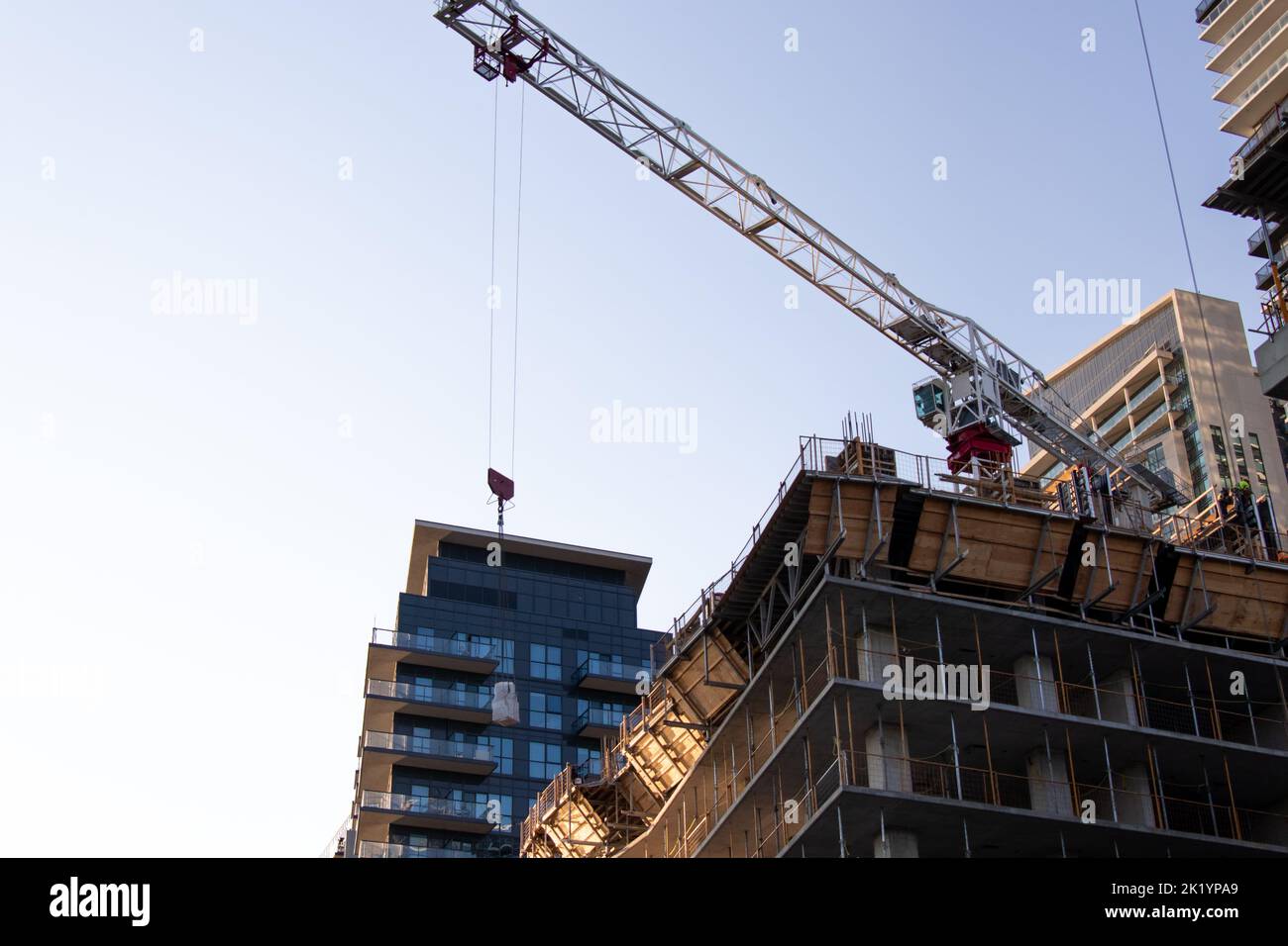 A closeup of a crane construction at work on a clear day. In operation ...