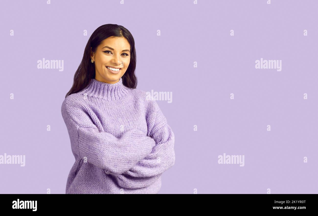 Smiling latin woman pose at purple studio background Stock Photo - Alamy