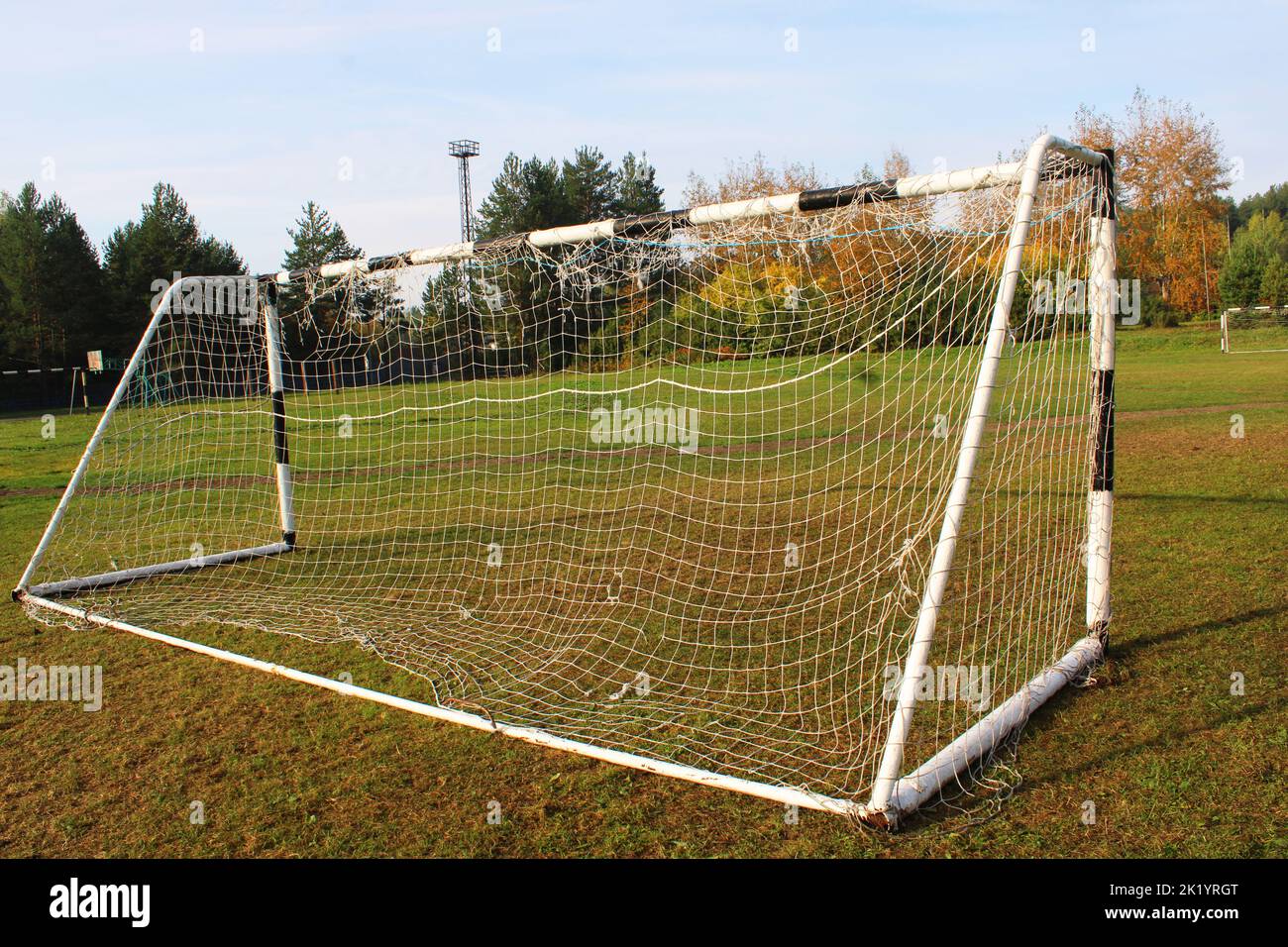 Old football goal against the background of the football field and ...