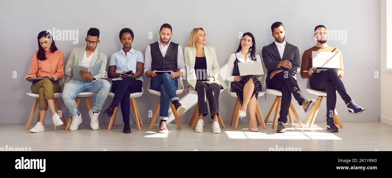 People reading or using devices while waiting for business appointment ...