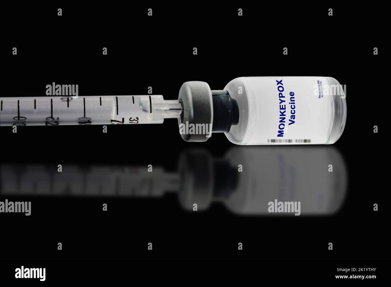 The monkeypox vaccine with a syringe close-up lies on its side against ...