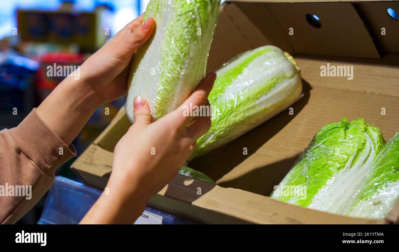 Buying Chinese cabbage in a store Stock Photo - Alamy