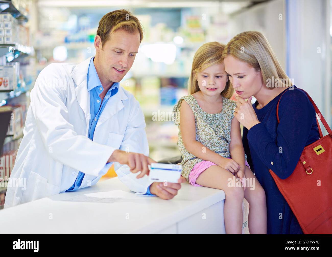 This will have her better in no time. A pharmacist giving medication to ...