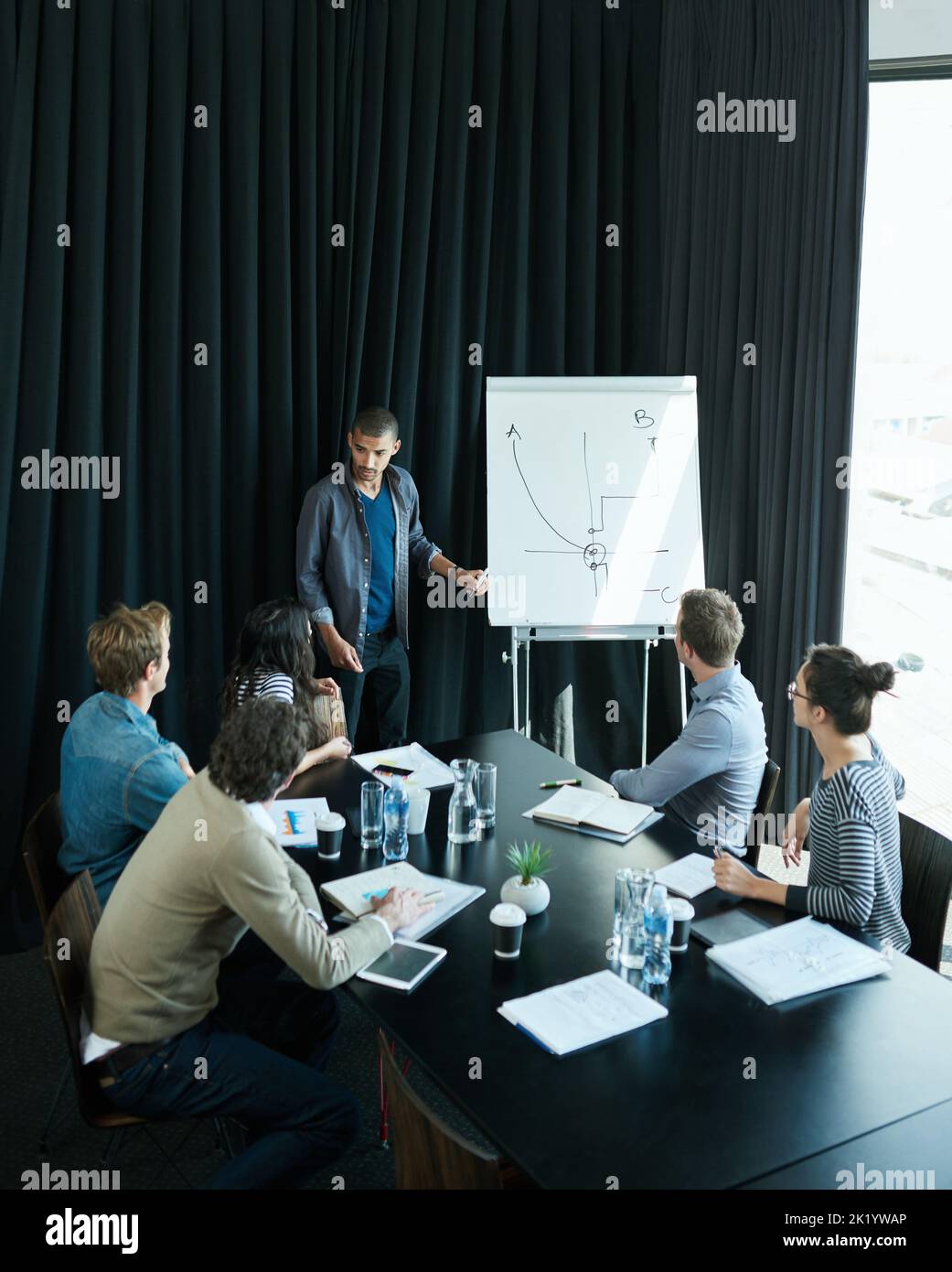 Showing the way from A to B. a young man giving a presentation on a ...