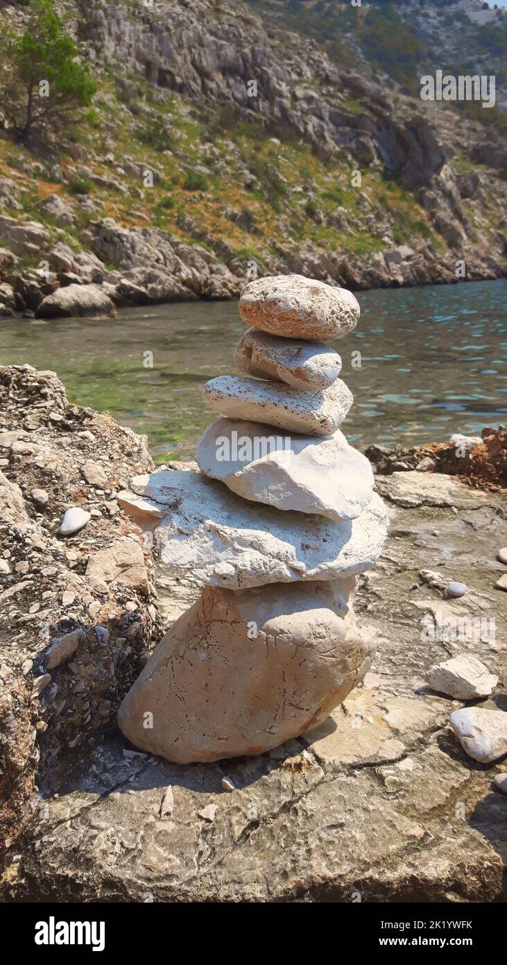 balanced Zen rocks art stacked in flowing water stream Stock Photo - Alamy
