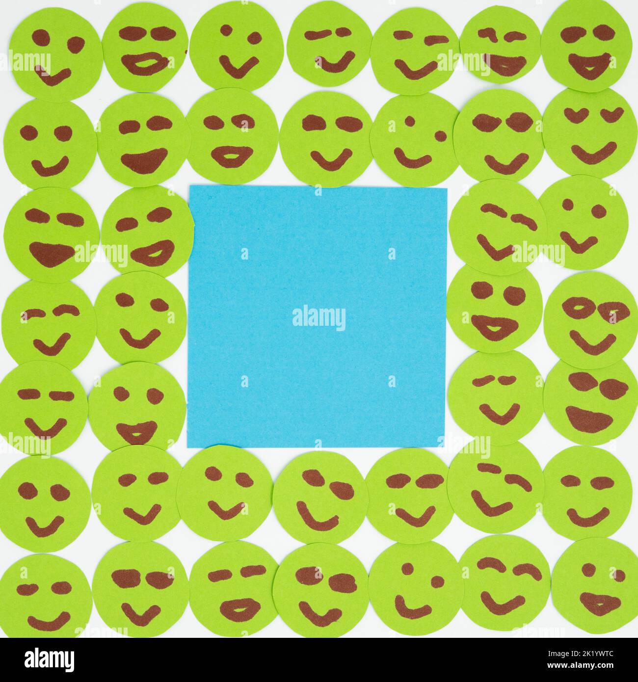 Creative flat lay layout made of paper faces and sticker about being ...