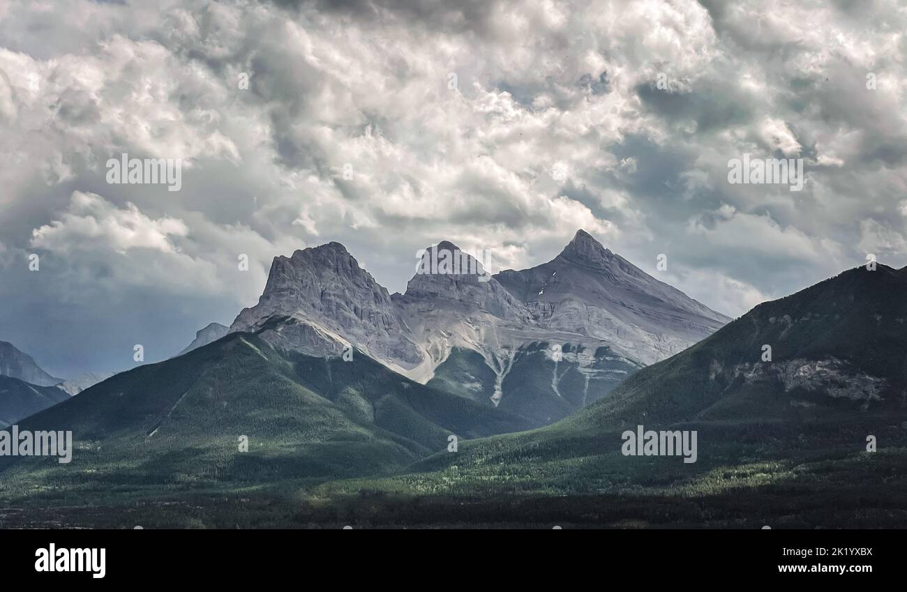 Three Sisters Mountain range against stormy sky in Banff, Canada Stock Photo - Alamy