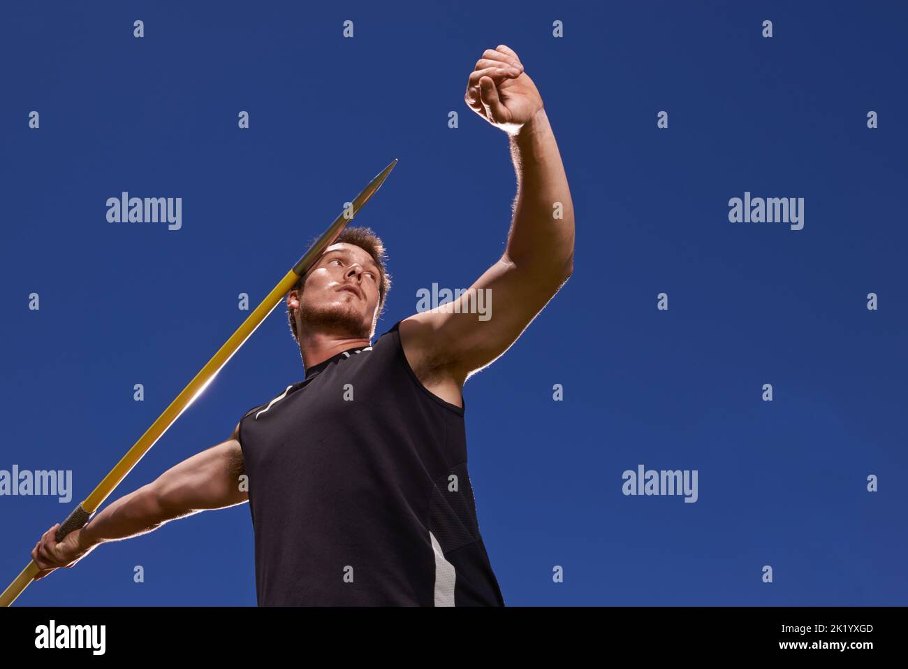 this is going the distance. a lone man throwing a javelin outside Stock ...