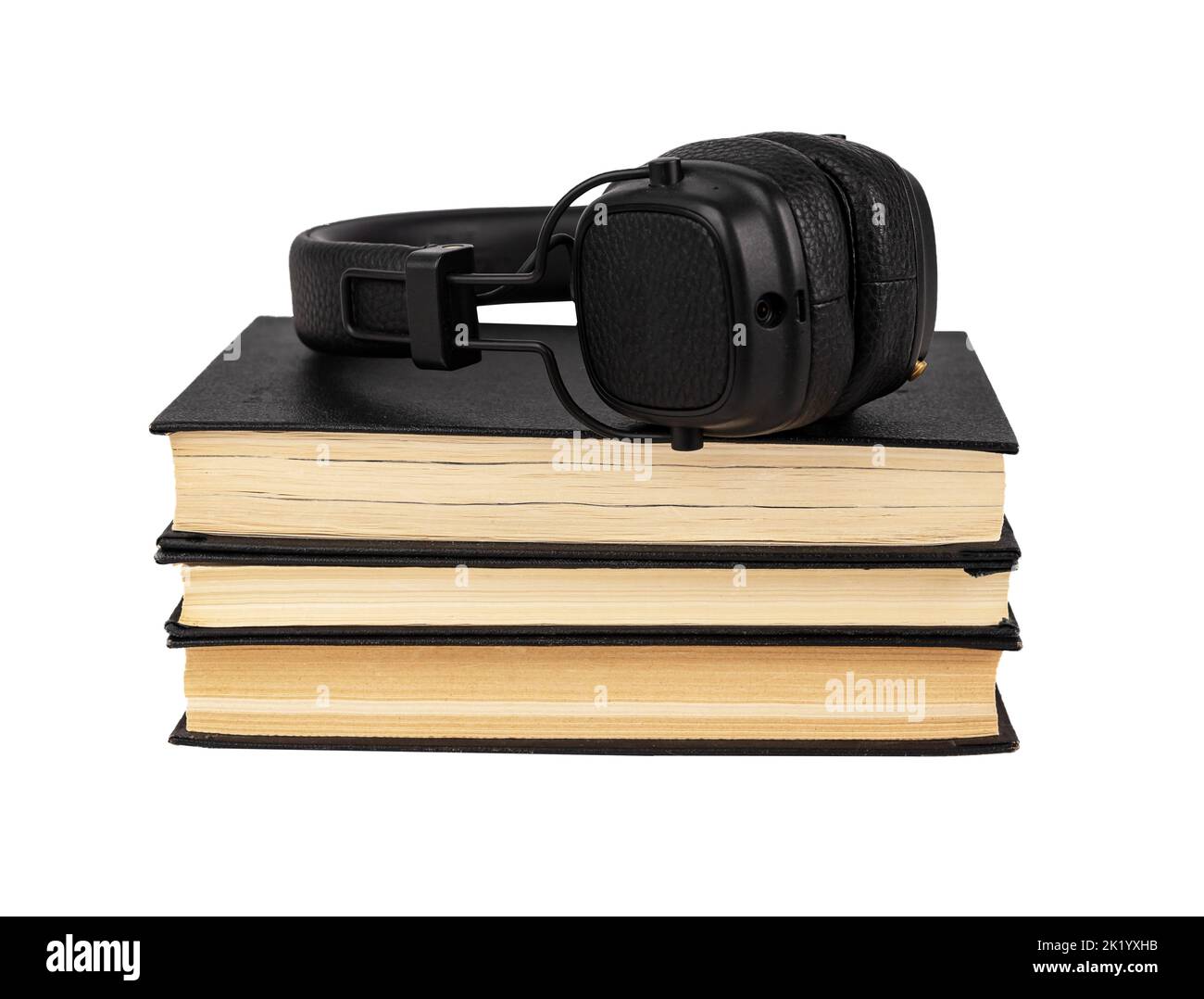 Headphones on books stack isolated on white background. Listening to audiobooks concept. Audio ...