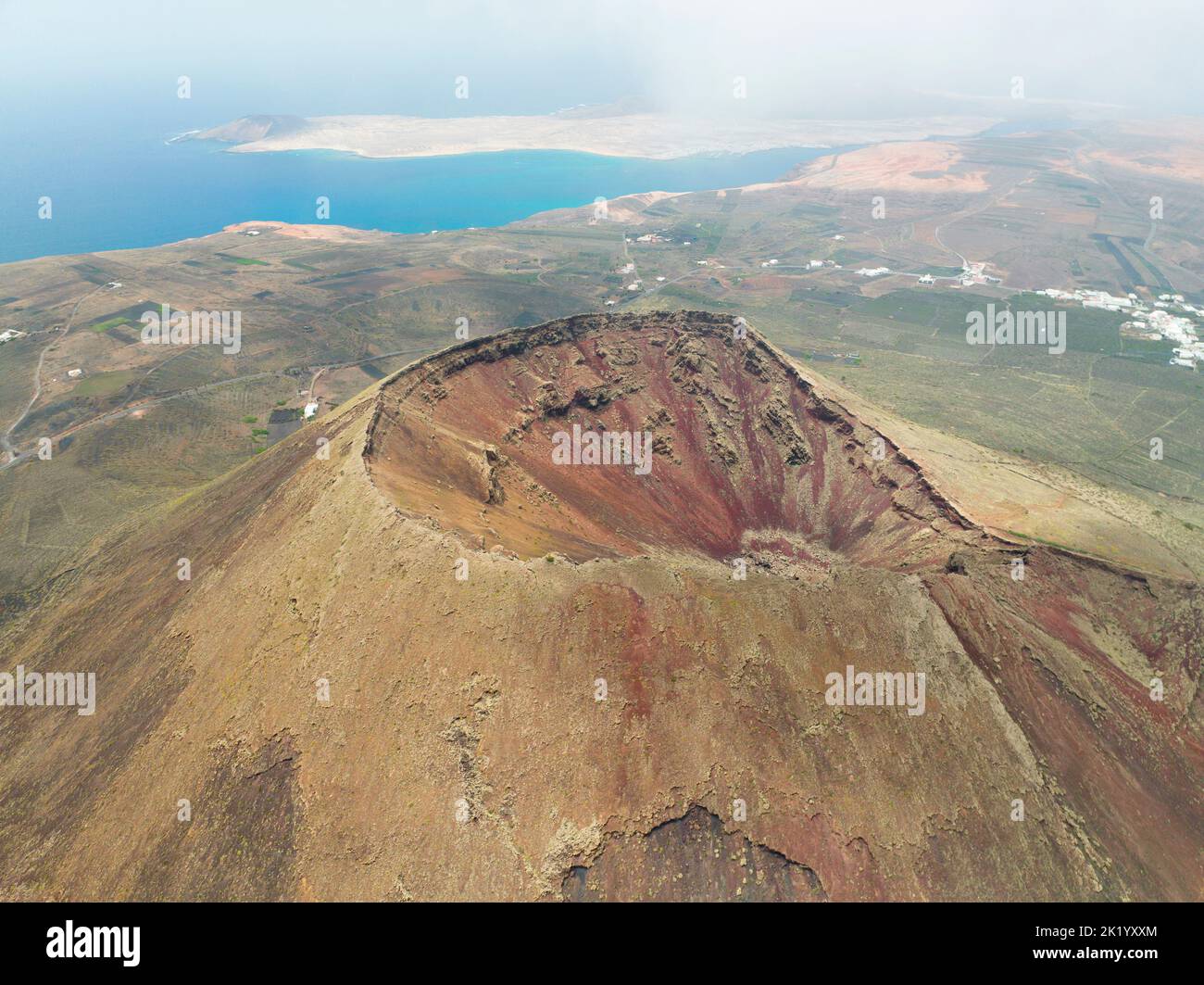 red volcano from aerial view close to sea Stock Photo - Alamy