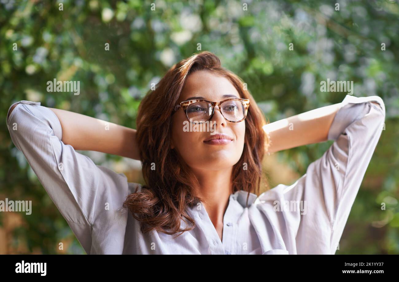 Spending some time in the sun. an attractive young woman relaxing ...