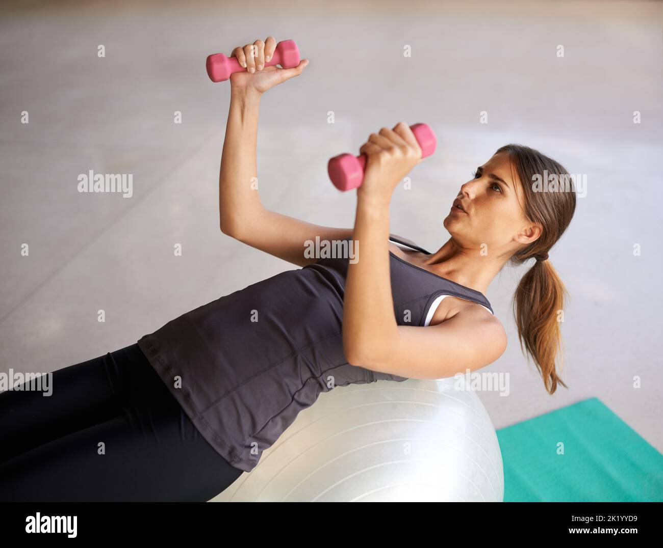 Dedicated to fitness. an attractive young woman working out in a studio ...