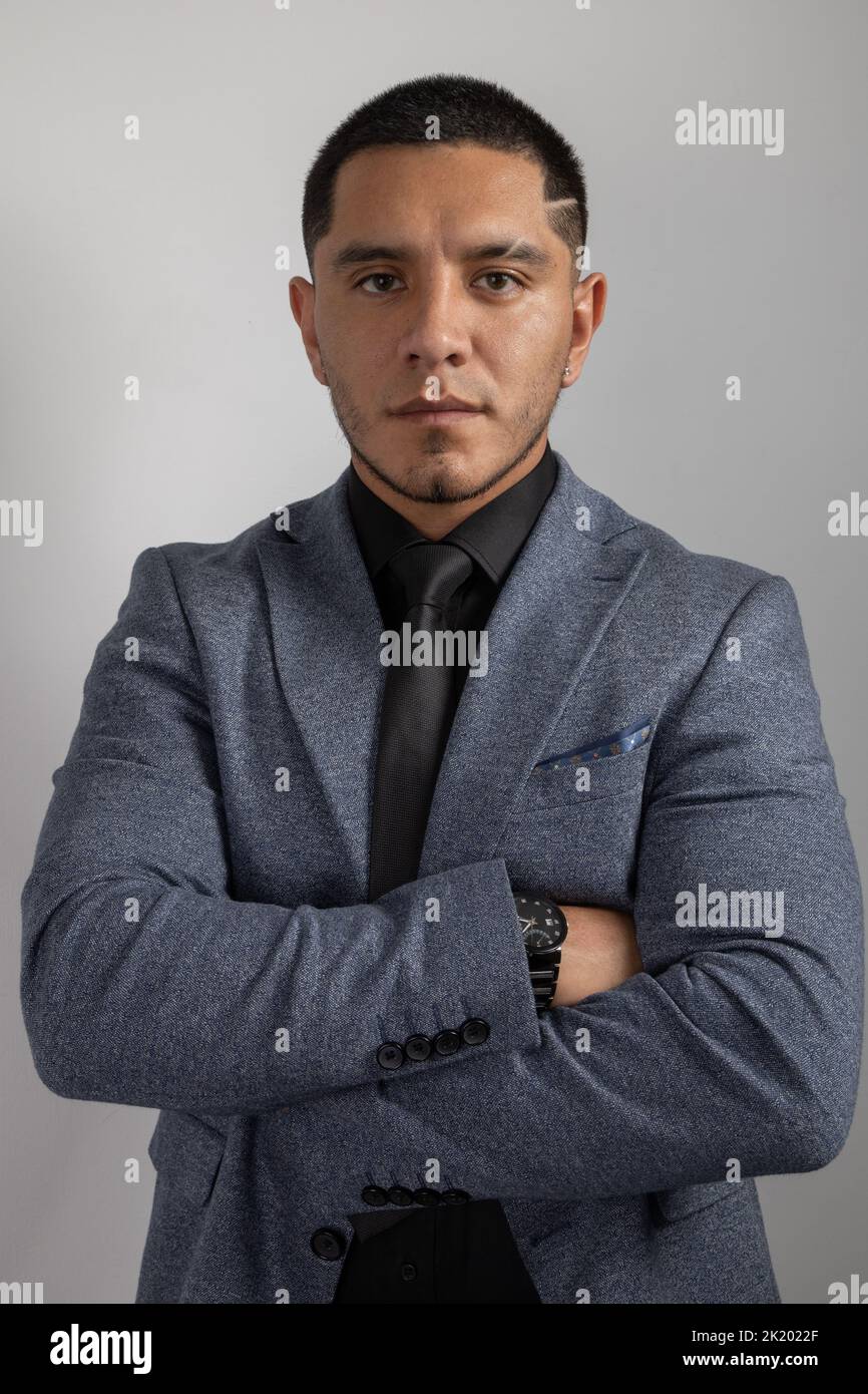 young latin man with short hair wears formal clothes, a suit, shirt and ...