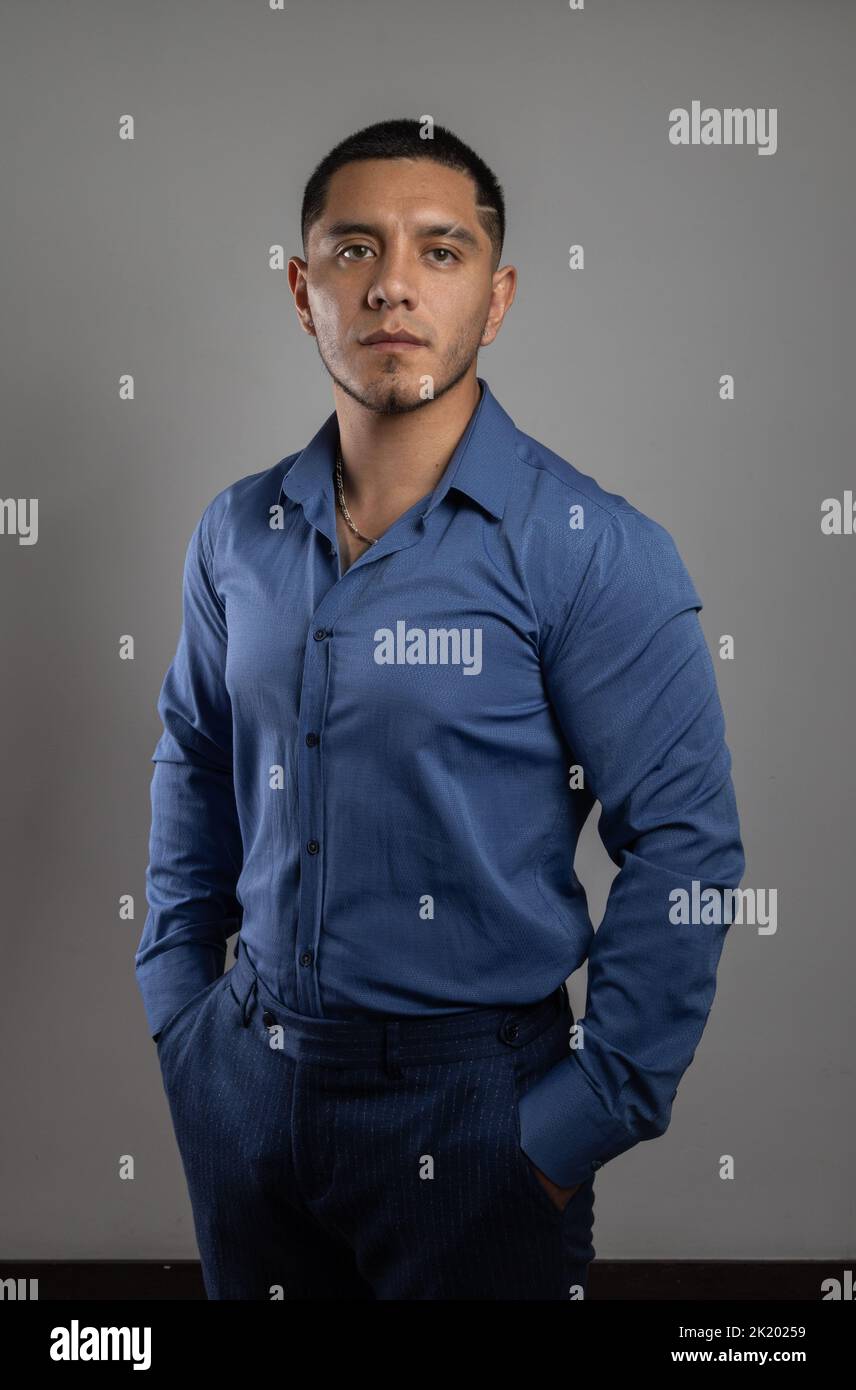 in studio wearing a blue shirt a young latin man with short hair ...