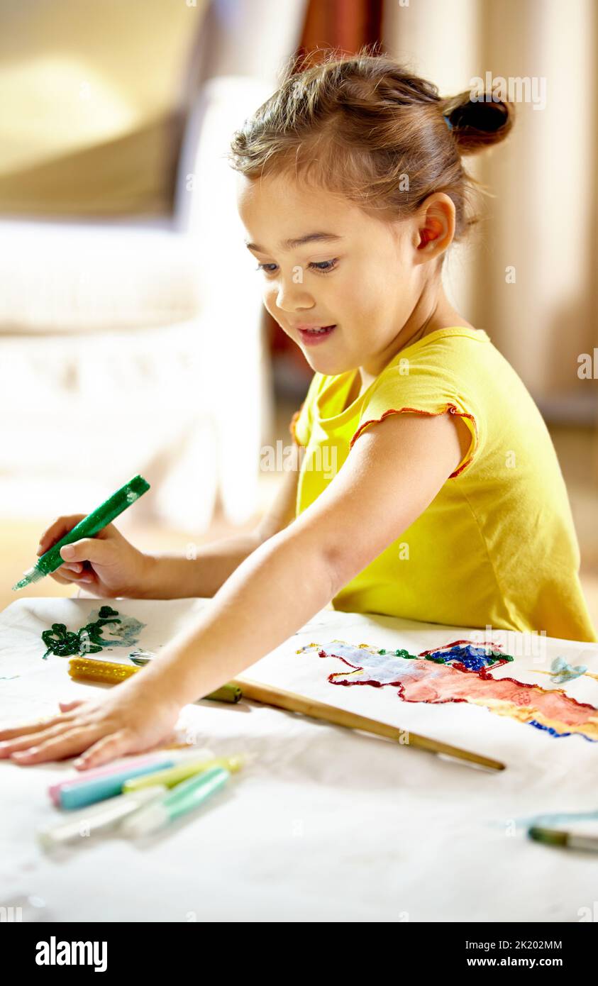 Creativity in progress. an adorable little girl making a mess while ...