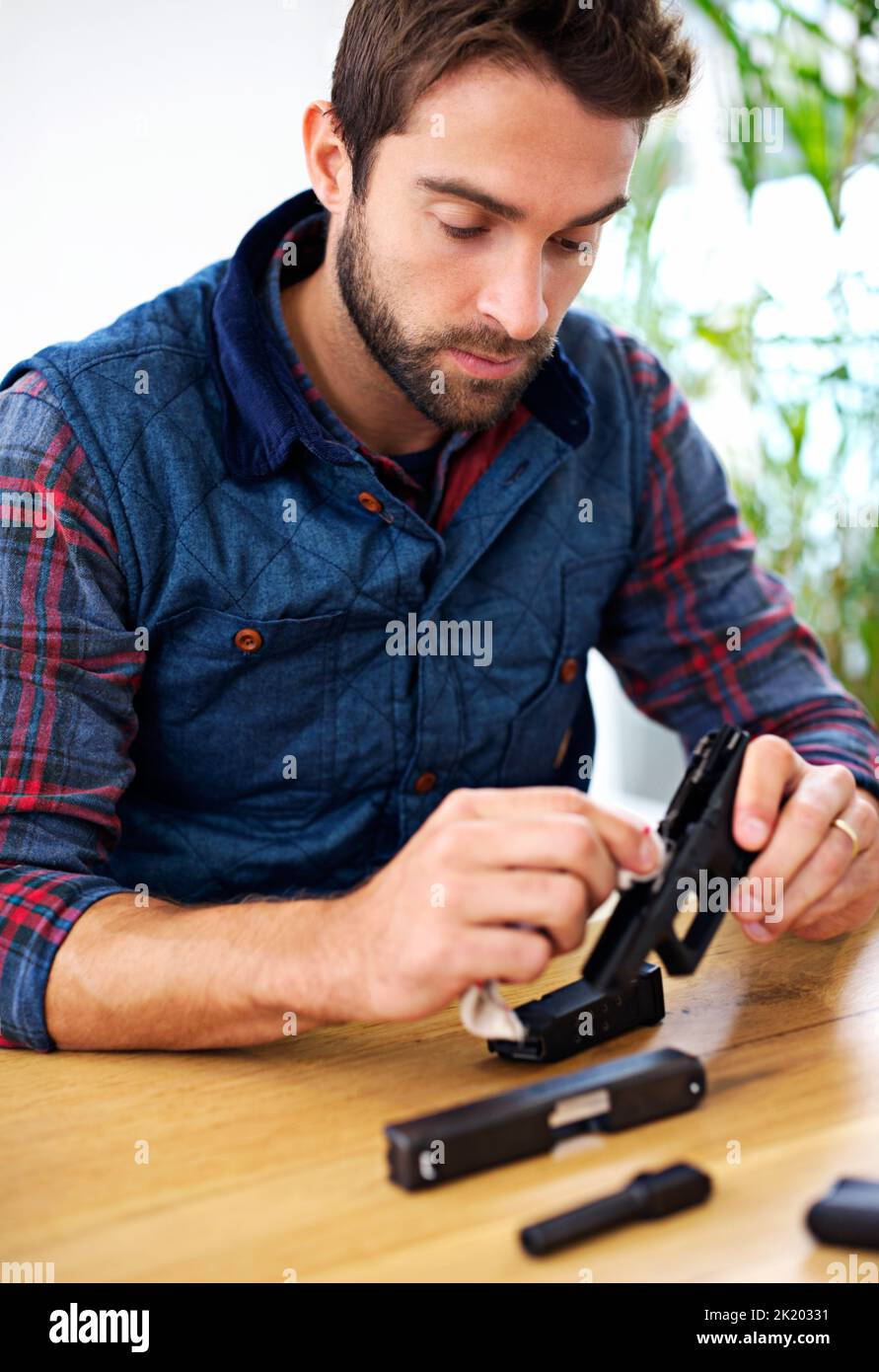 Regular maintenance is essential for every gun owner. A young man ...