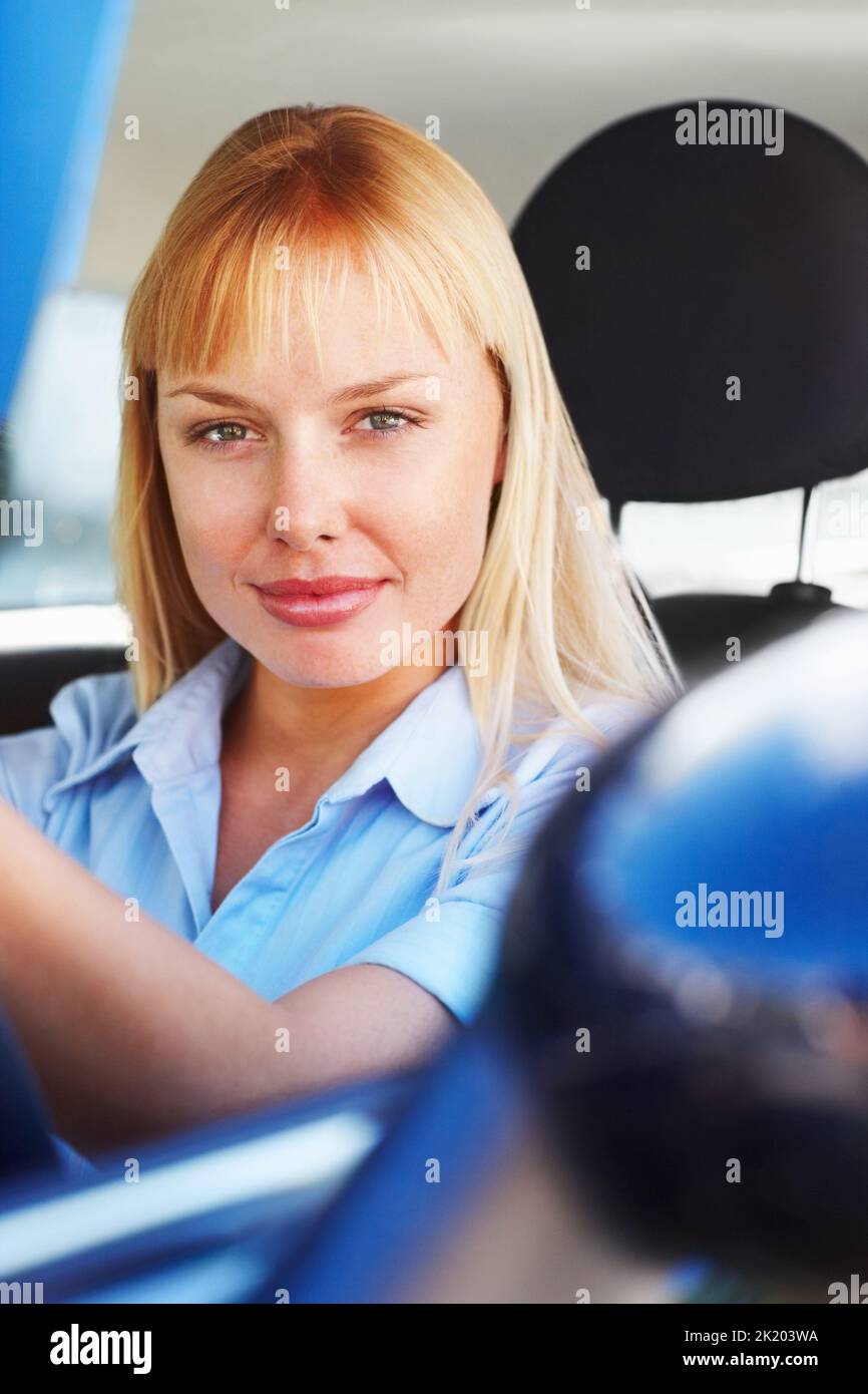 Beautiful young blond woman in a car. Portrait of a pretty blond female ...