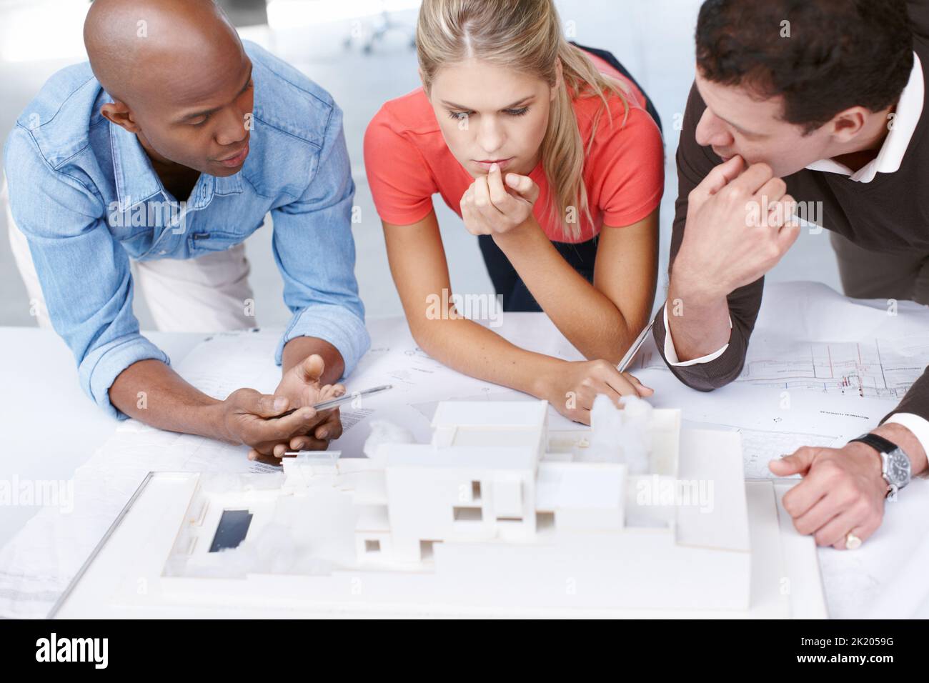 At the architects table...A group of architects working together on an ...