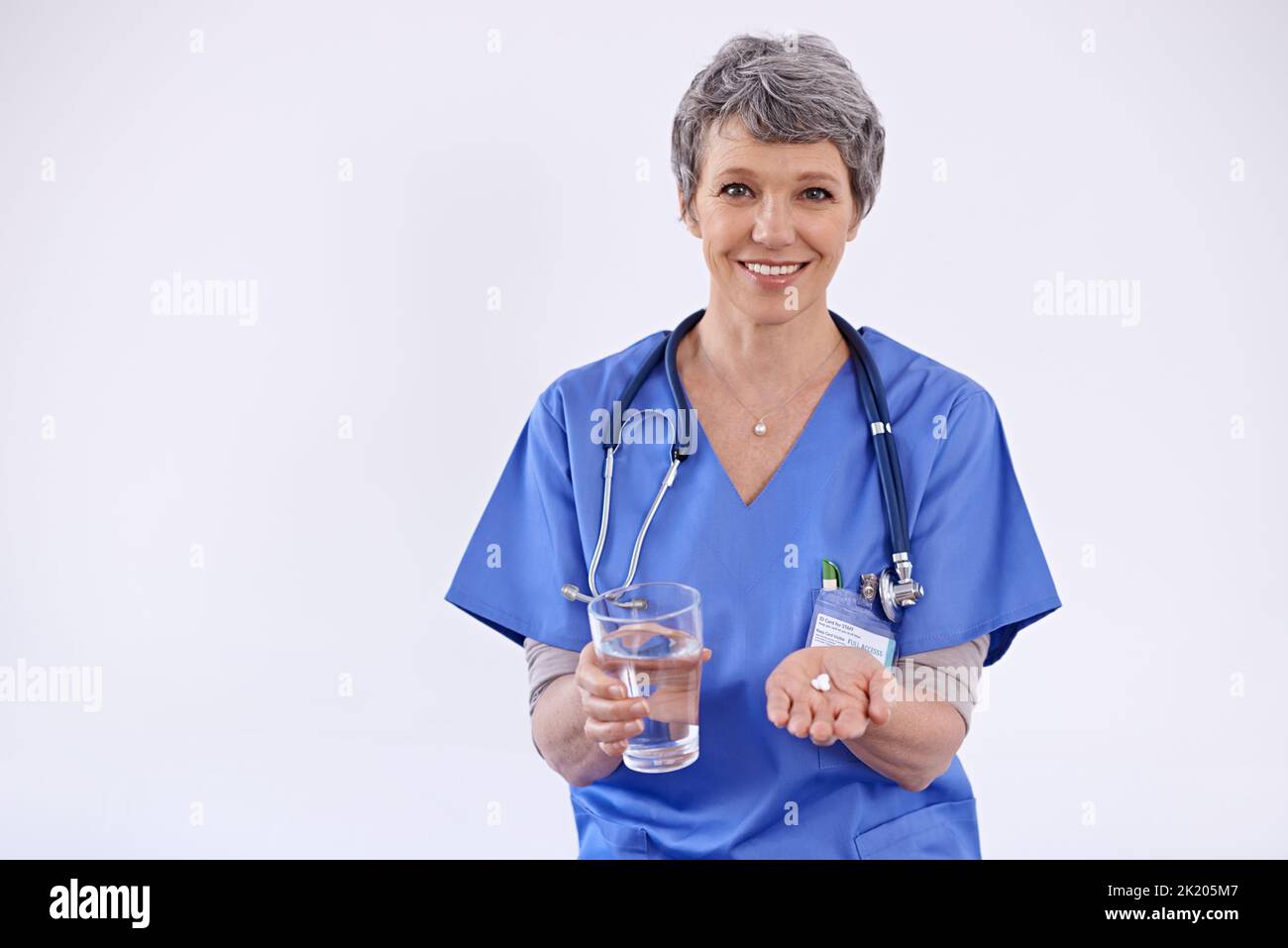 This will help you feel better. a female doctor holding medication and ...