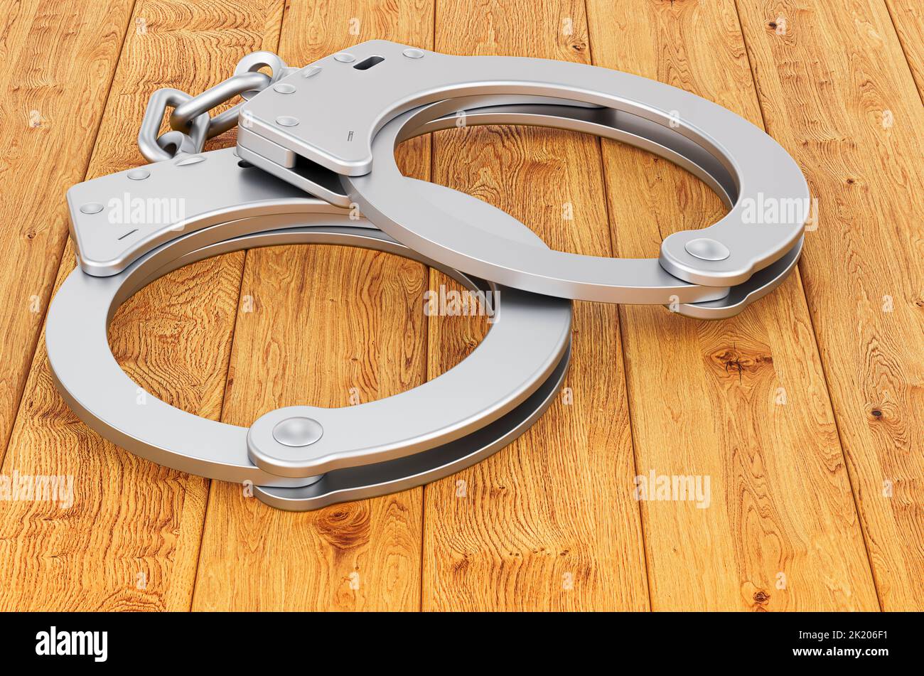 Handcuffs on the wooden table, 3D rendering Stock Photo - Alamy