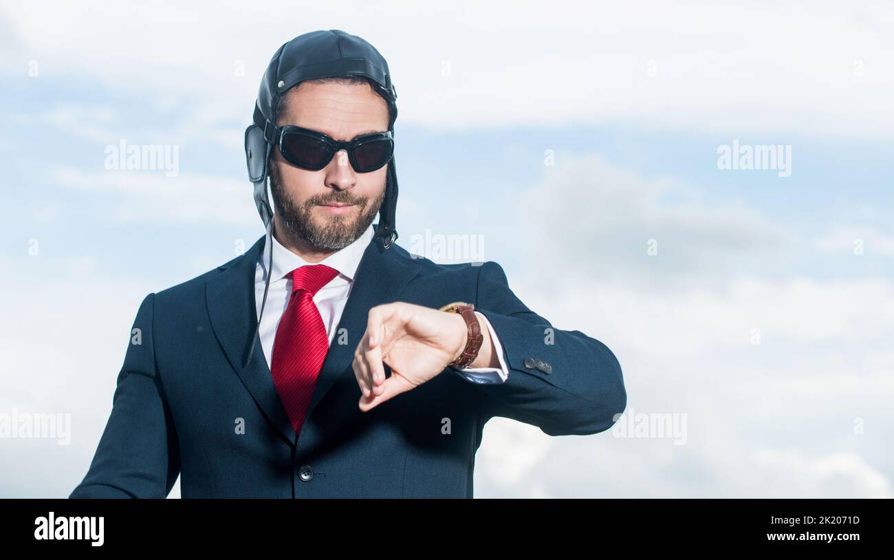 businessman in suit and pilot hat check time Stock Photo - Alamy