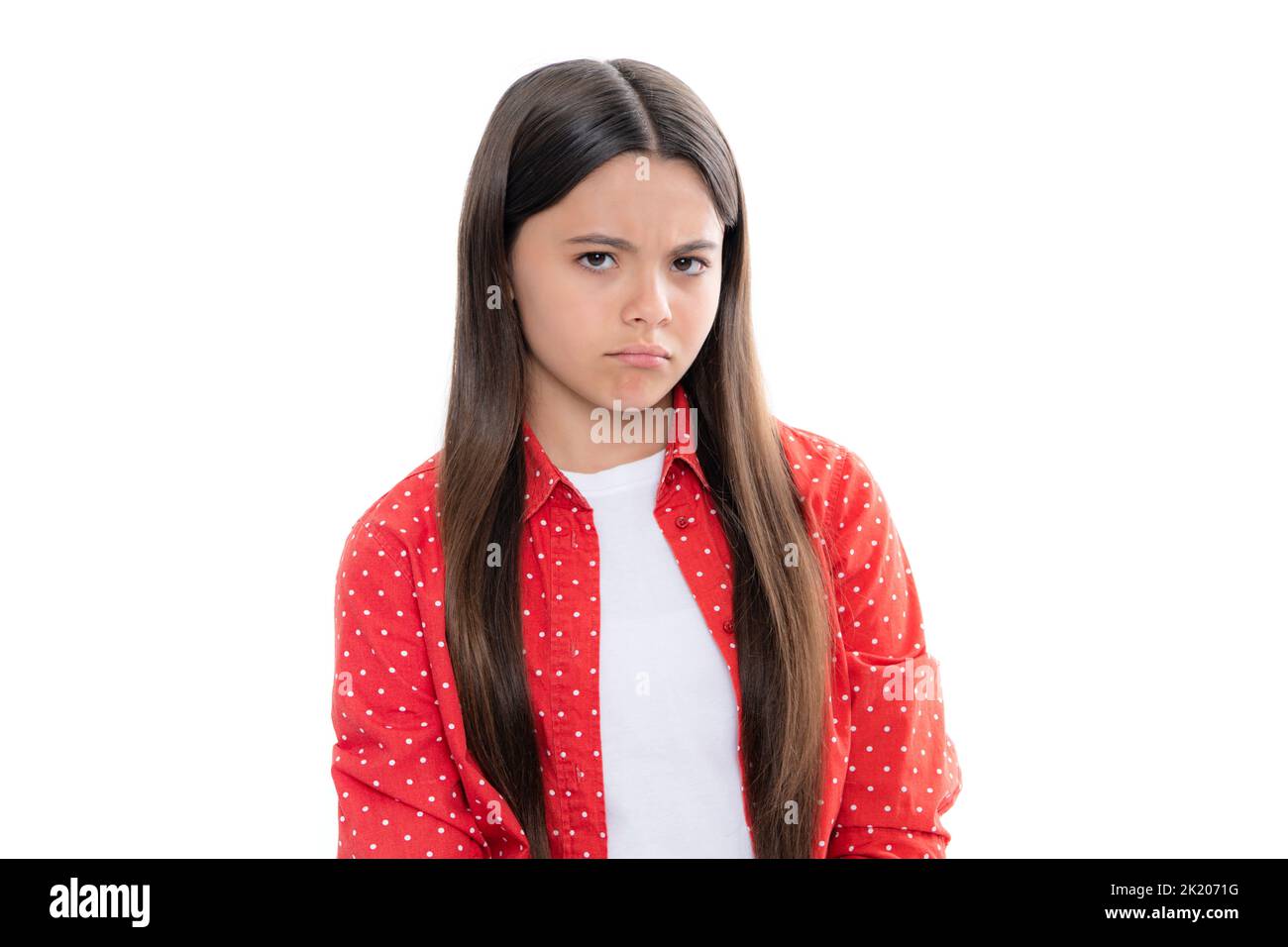 Portrait of angry teen girl looking at camera isolated on studio ...