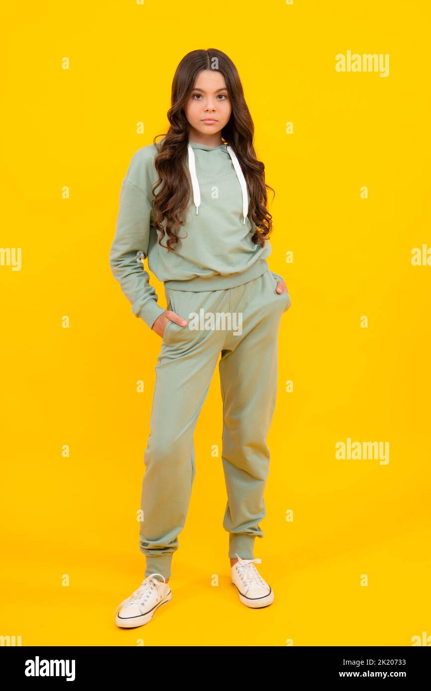 Beautiful teenager child girl in a sports suit, tracksuits. The girl in ...