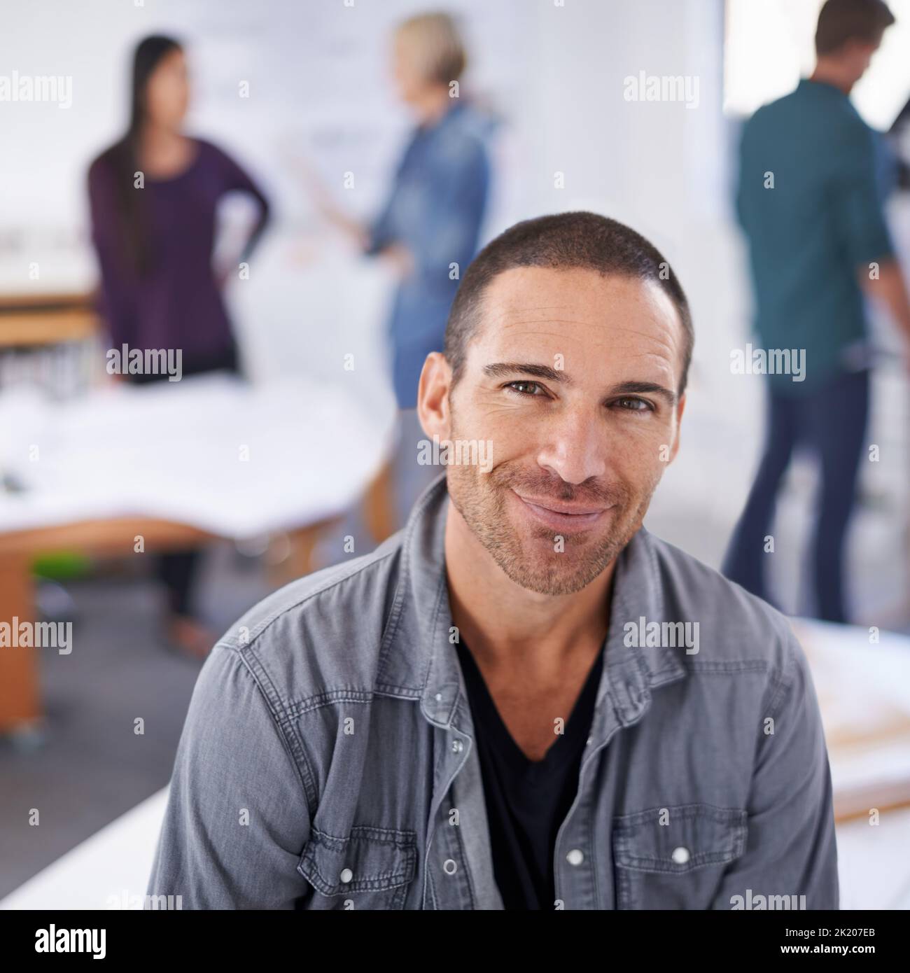 Enjoying a quiet day in the office. Portrait of an architect standing ...