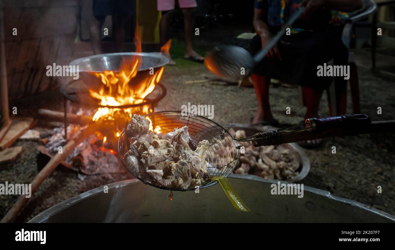 Rural people cooking large meals with wood and basic pottery Stock ...