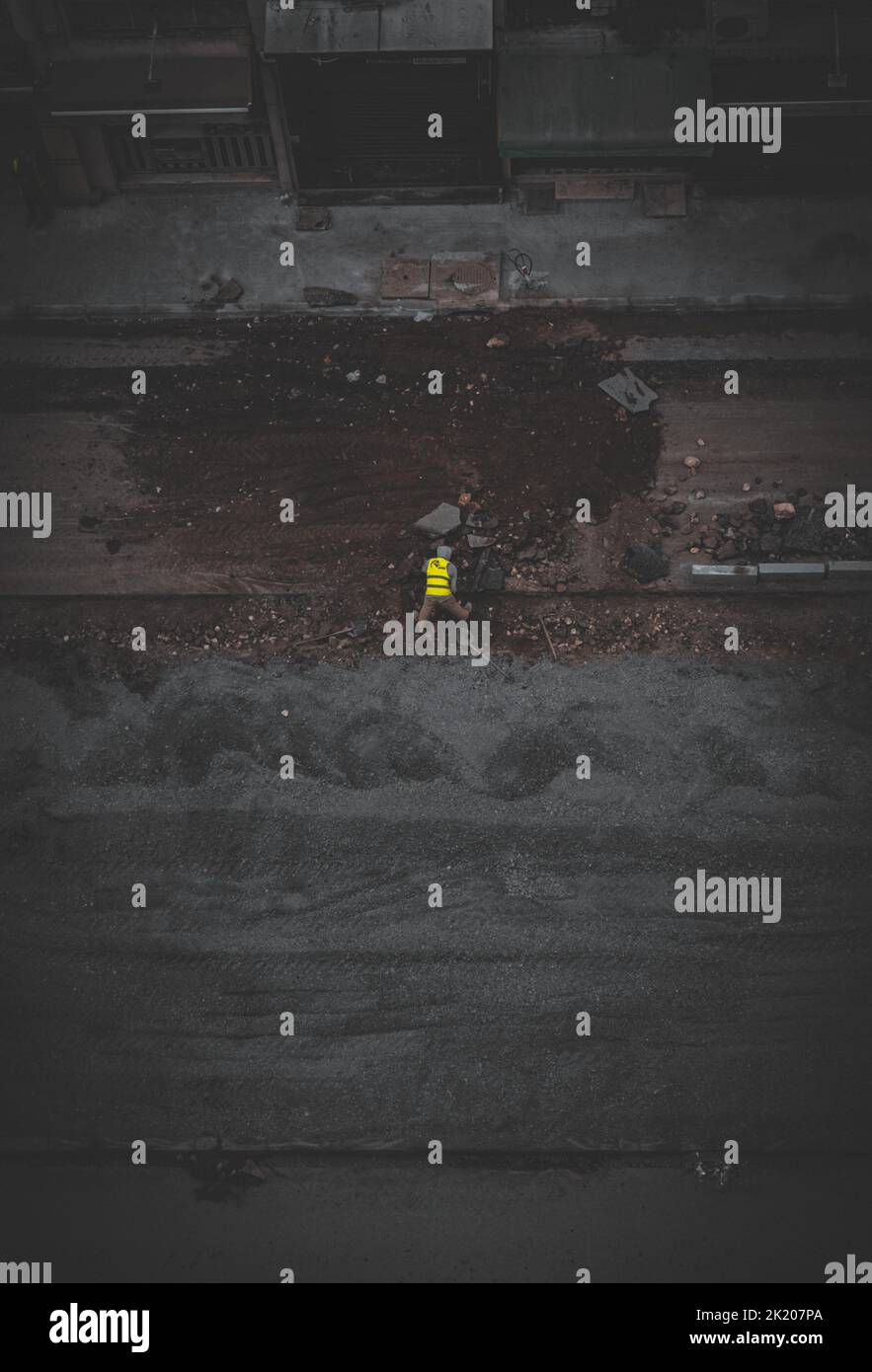 A vertical aerial view of a male working on the construction site Stock ...