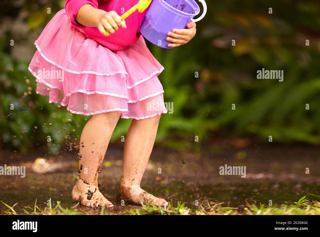 Let the muddy fun begin. a little girl playing outside in the mud Stock ...