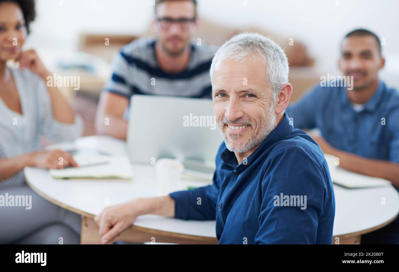 Leading by experience. Portrait of a group of designers at work in an ...