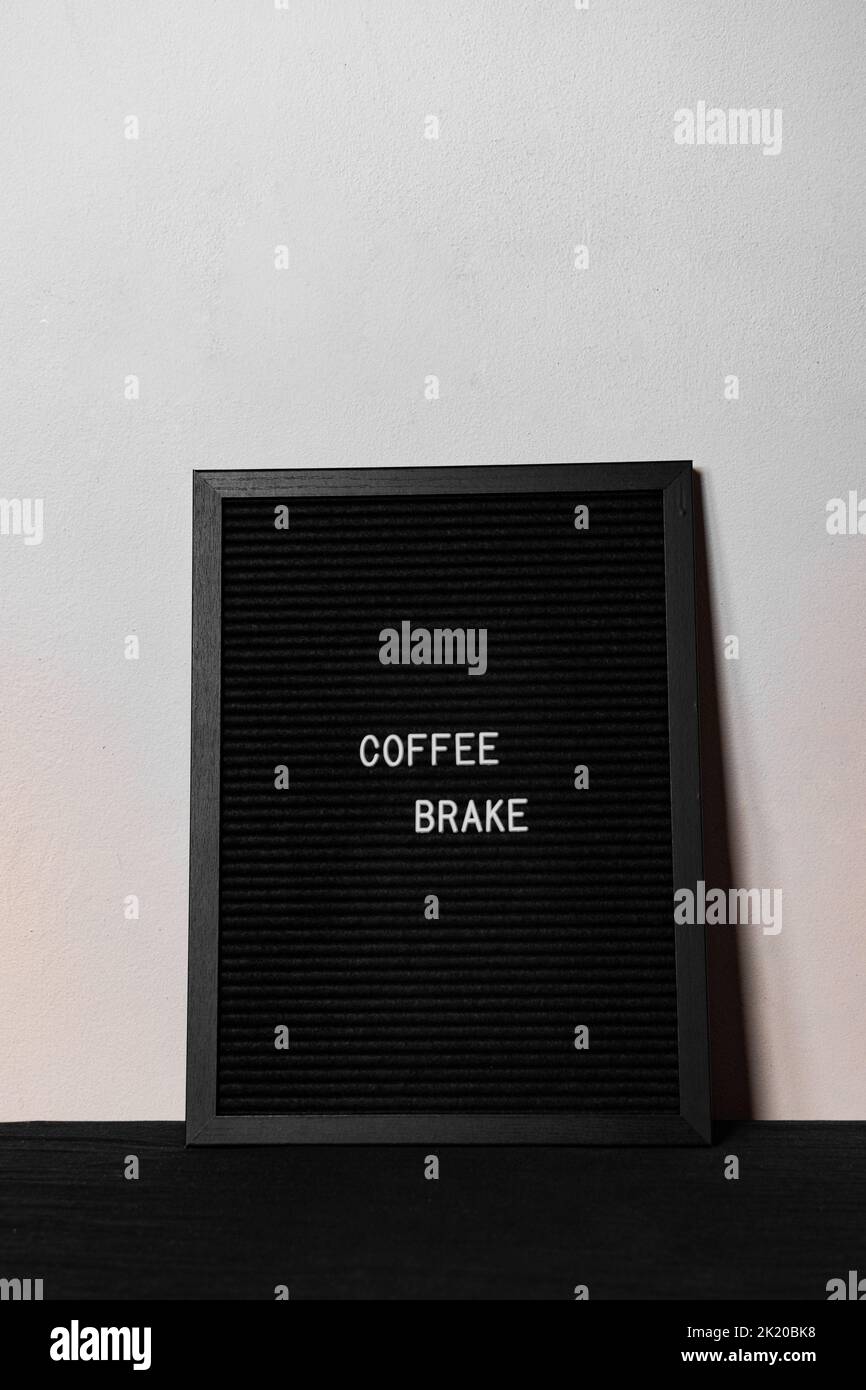 A vertical black spongy board with the text "coffee break" for ...