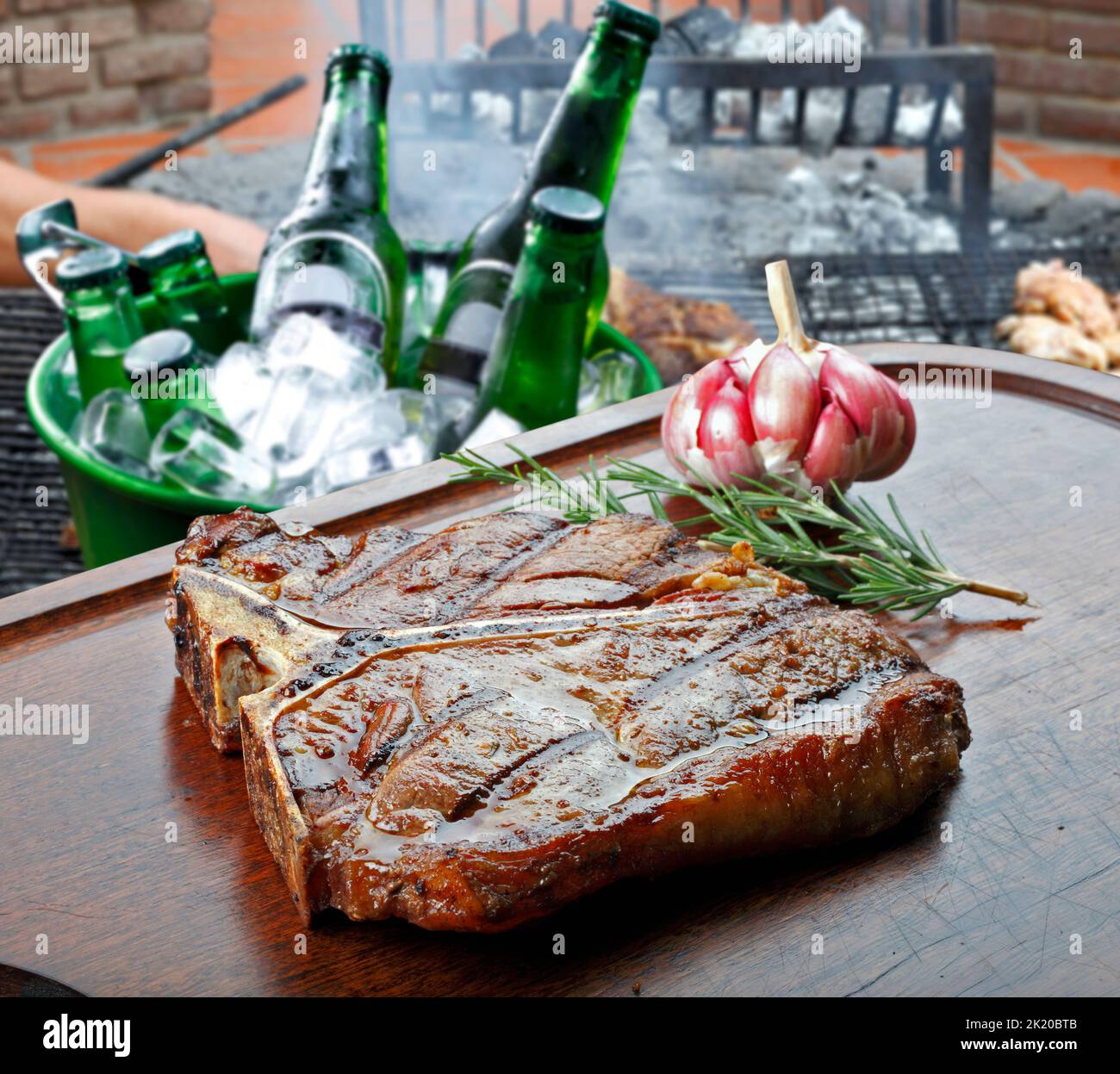 Barbecue with beer and t bone steak Stock Photo - Alamy
