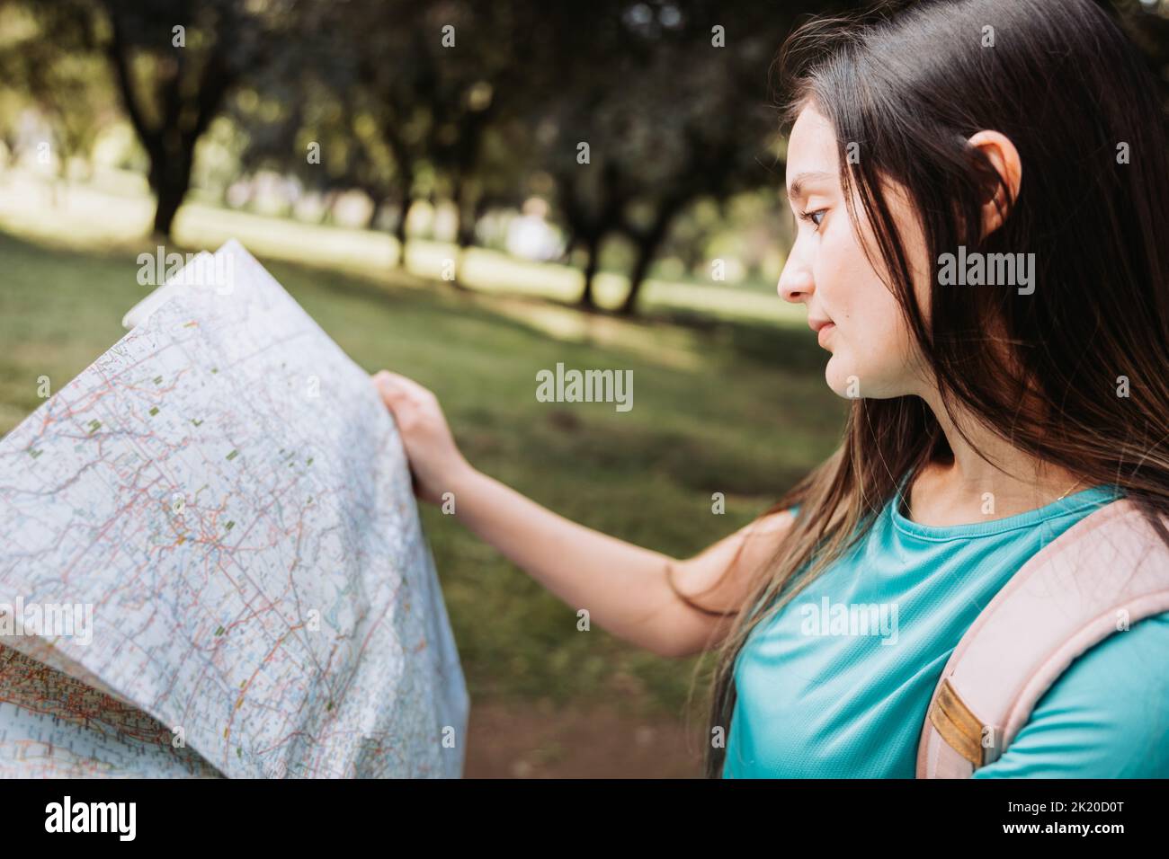 Young girl tourist, wearing turquoise t shirt and a pink backpack ...