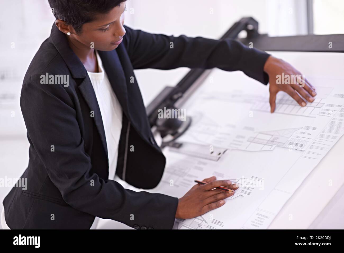 She prides herself in her accuracy. a female architect working at a ...