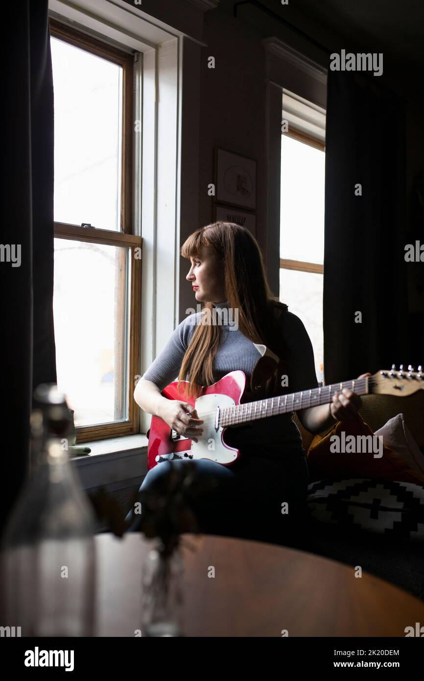Woman playing guitar electric hi-res stock photography and images - Alamy