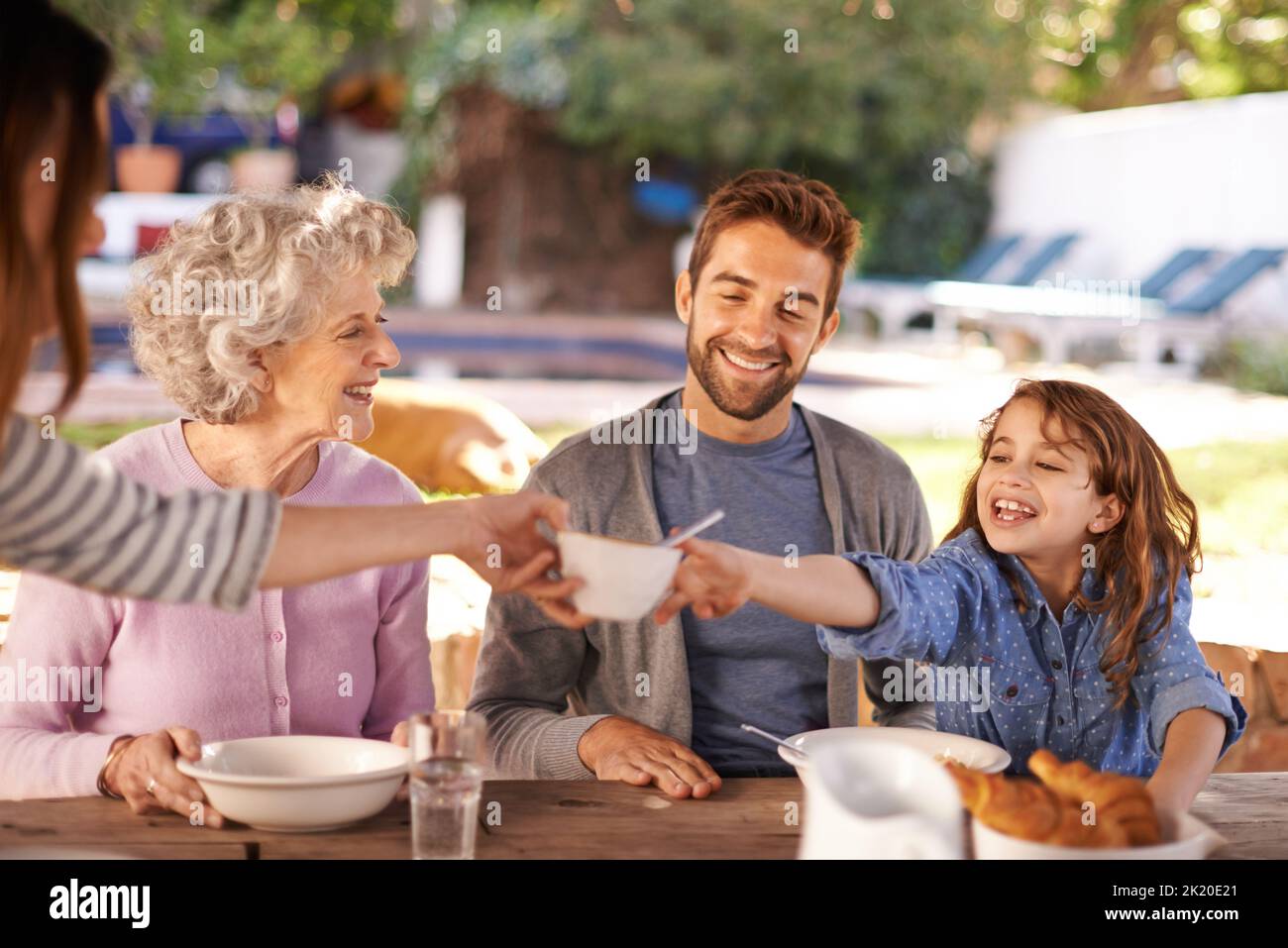 Sharing a scrumptious meal. a family having breakfast together outside ...