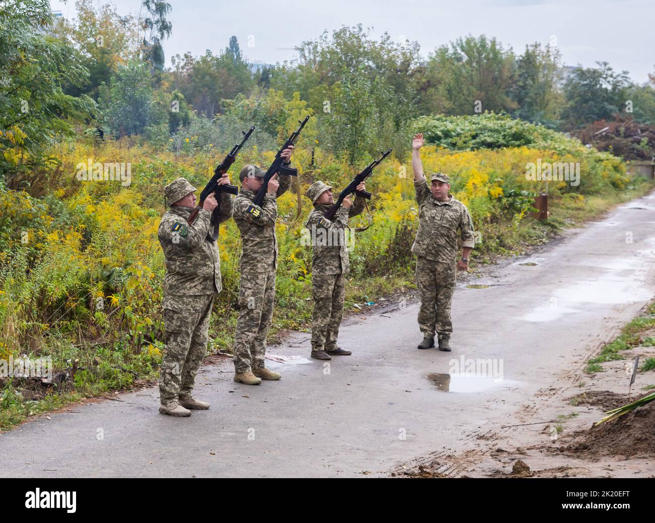 A group of military salutes from automatic weapons in honor of the ...