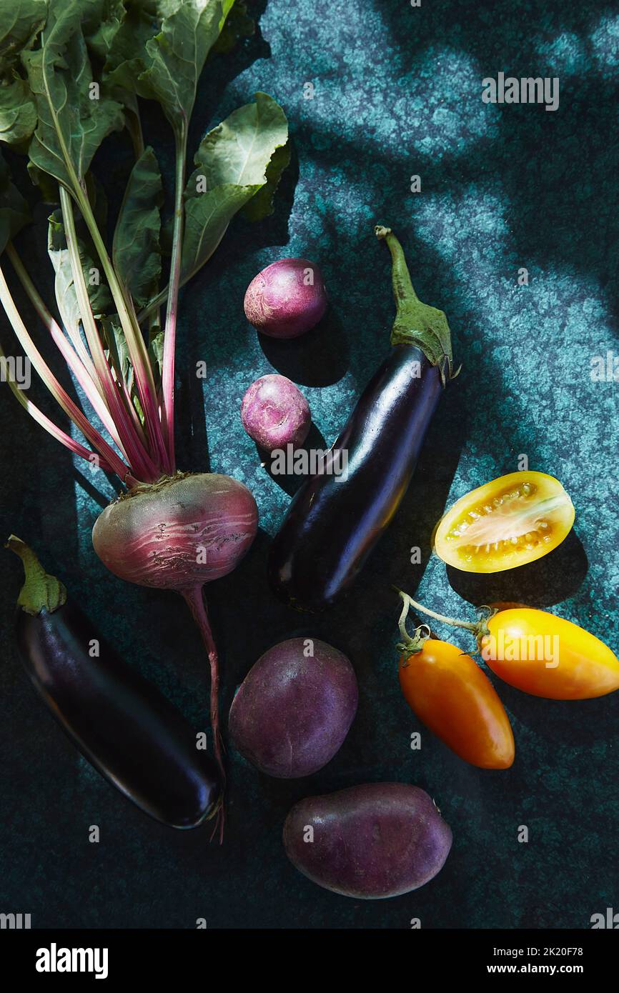 Seasonal vegetables - yellow tomatoes, eggplant, beetroot under trendy ...