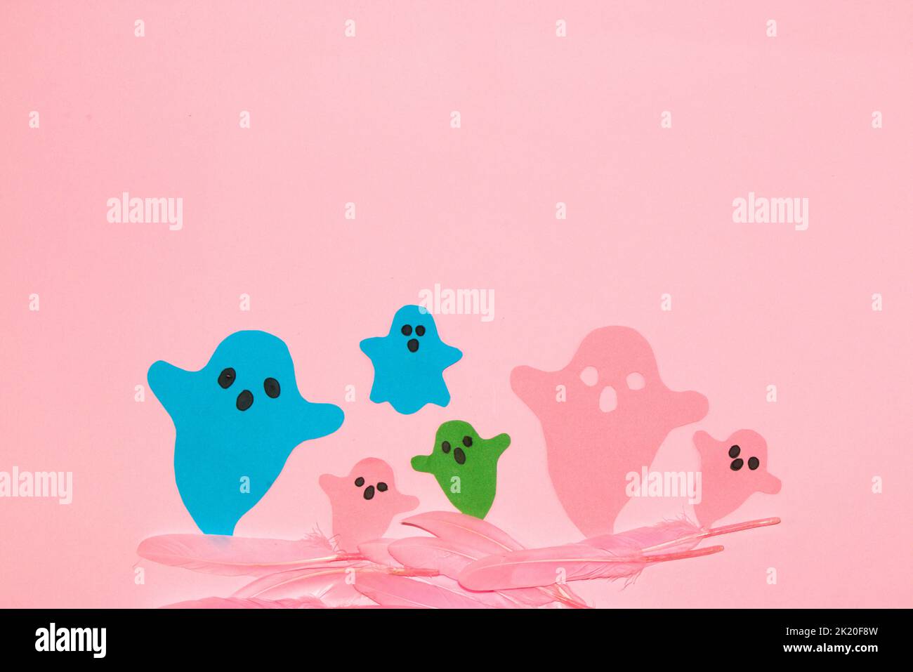 colorful ghosts at the bottom of pink background on pink feathers ...