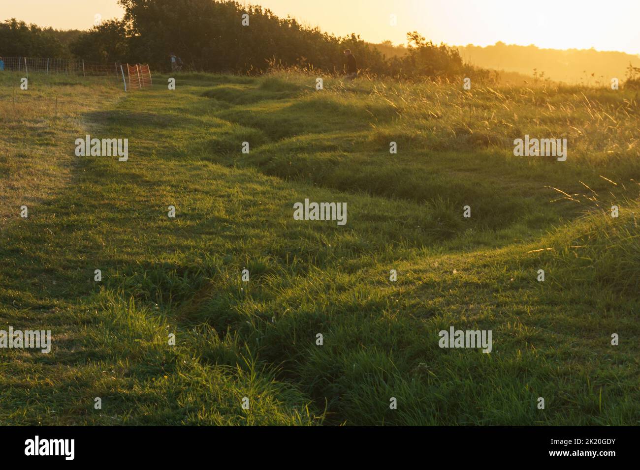 Golden sunlight at sunset over a Meadow with traces of former german ...