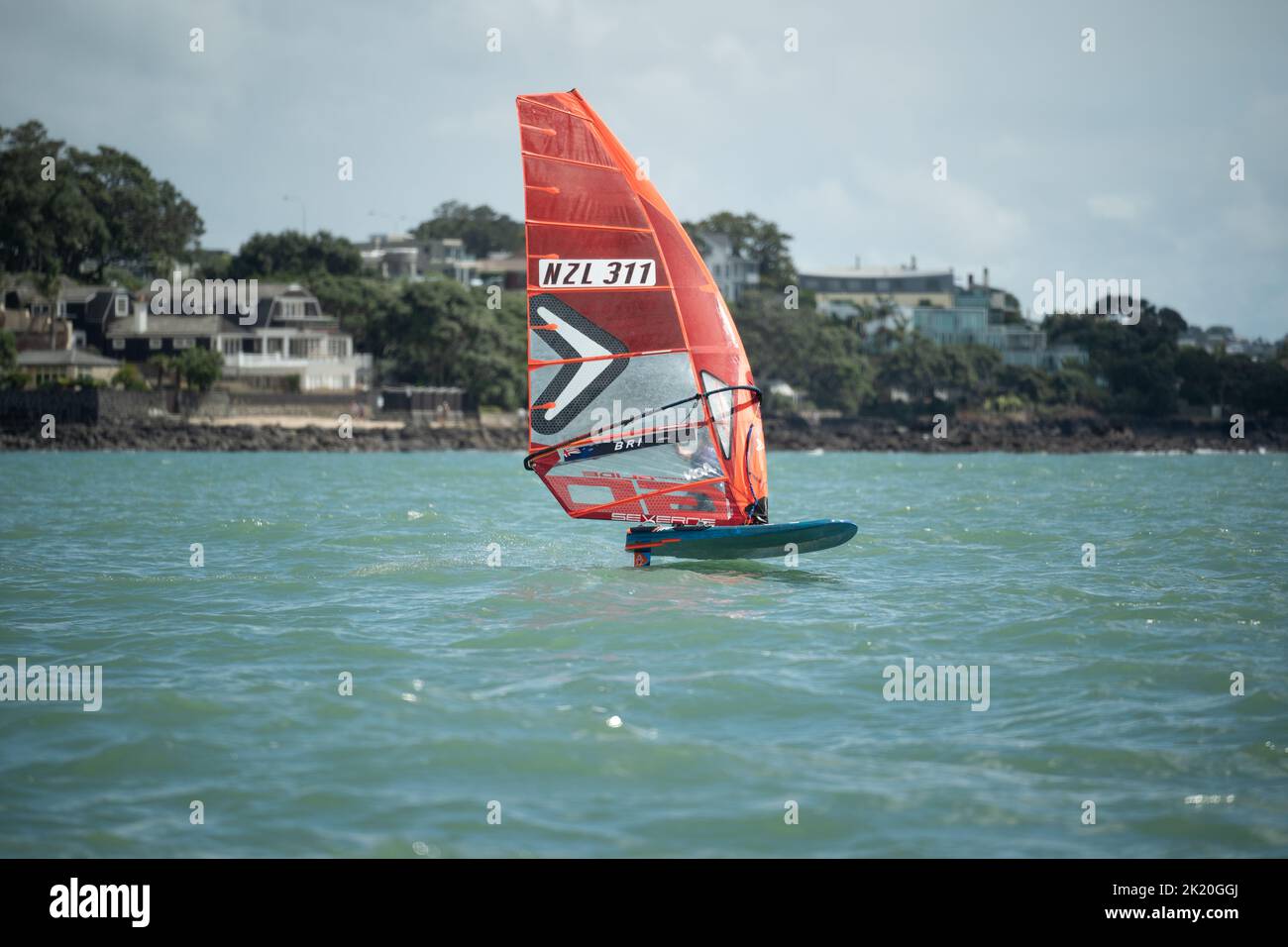 A man competes in a national windsurfing hydrofoil race at the ...
