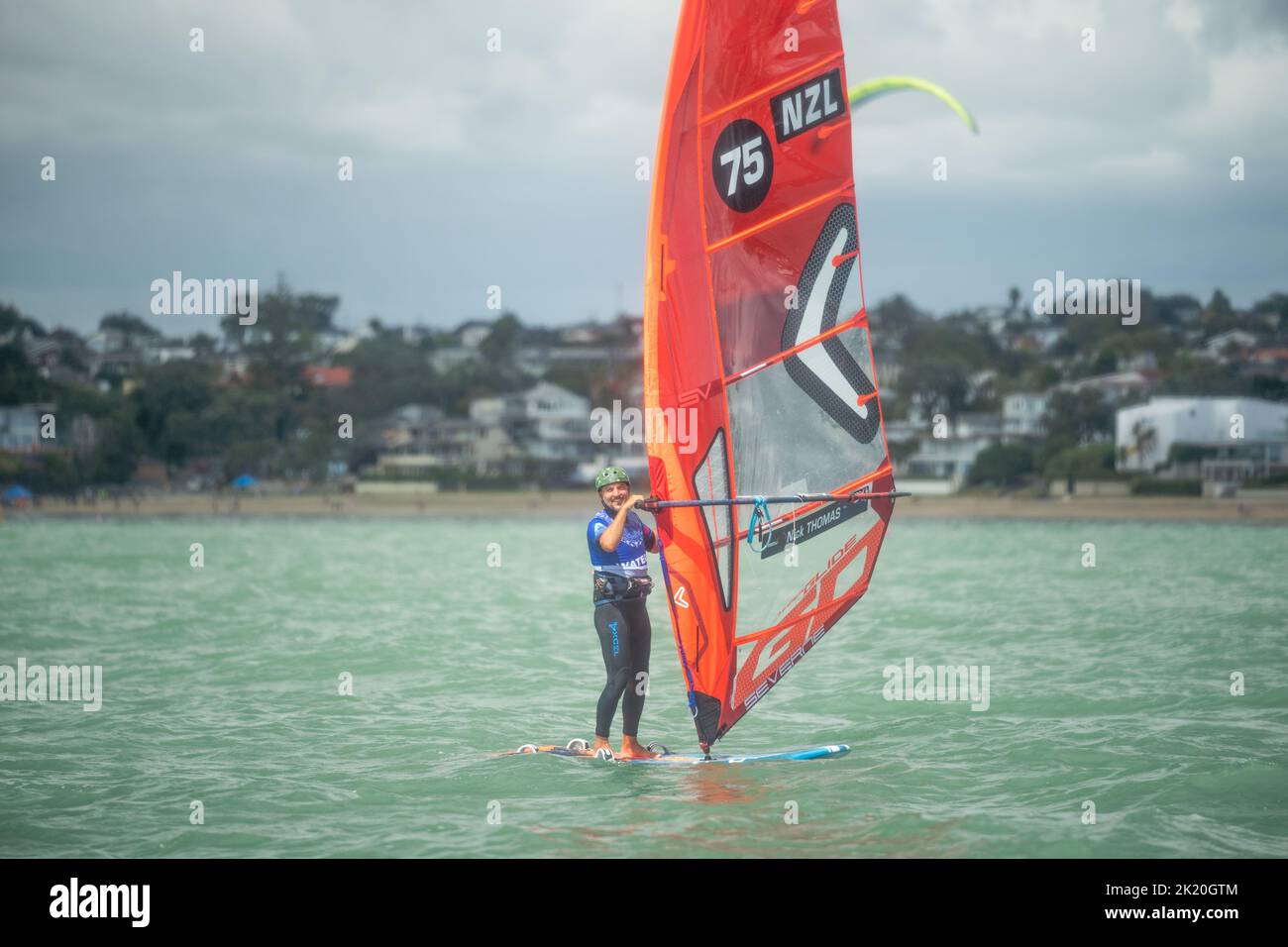 A woman competes in a national windsurfing hydrofoil race at the ...